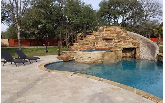 Rock Grotto spa and slide by Loy Custom Pool Designs LLC in Cedar Park ...